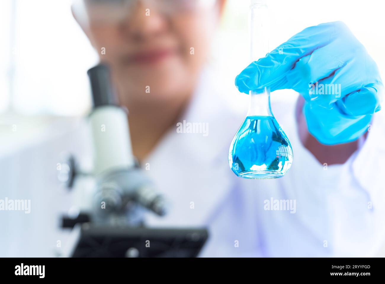 Female scientist hold and showing laboratory test tubes and solution ...