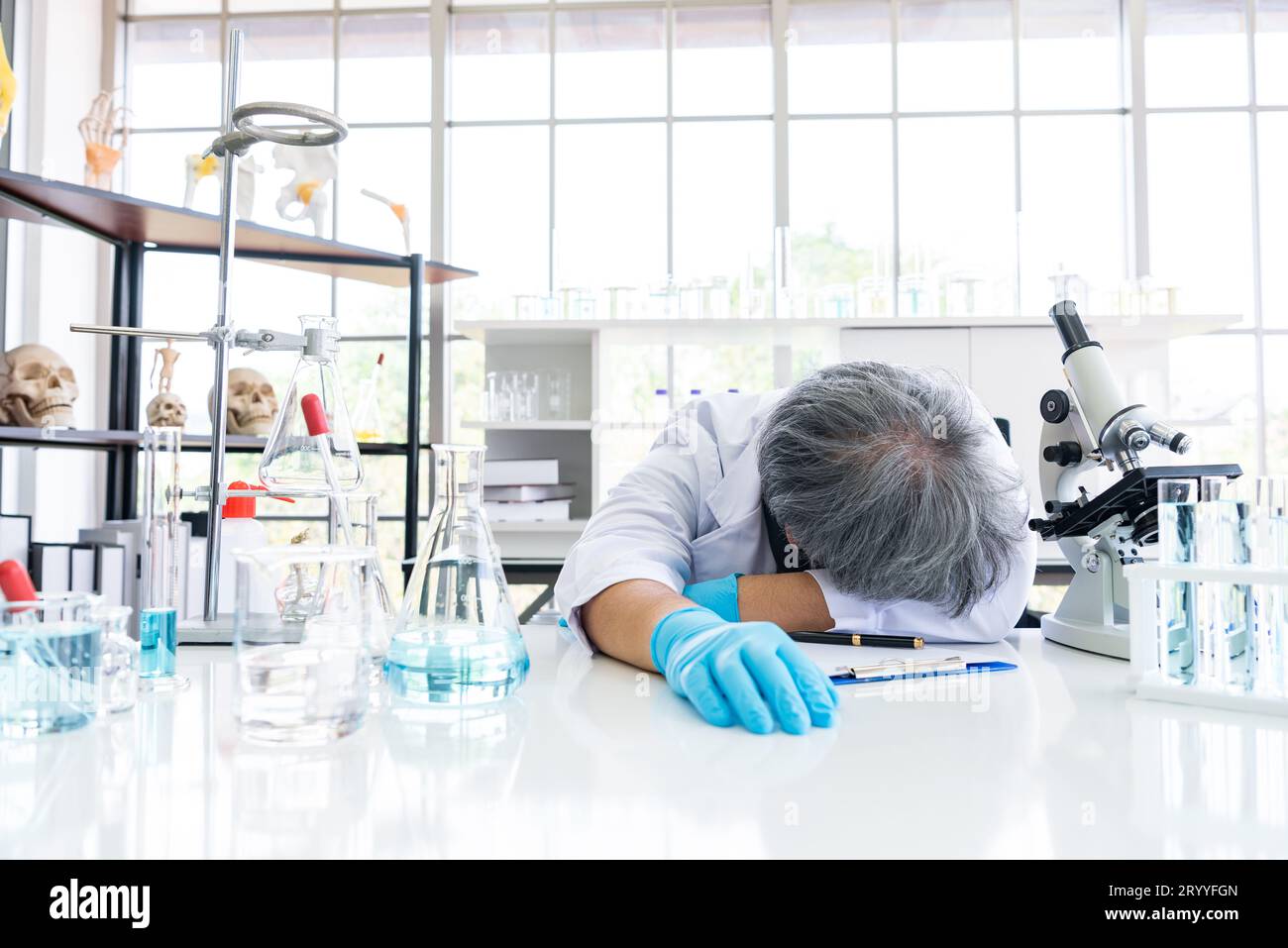 Exhausted scientist sleeping in laboratory. People lifestyles and ...