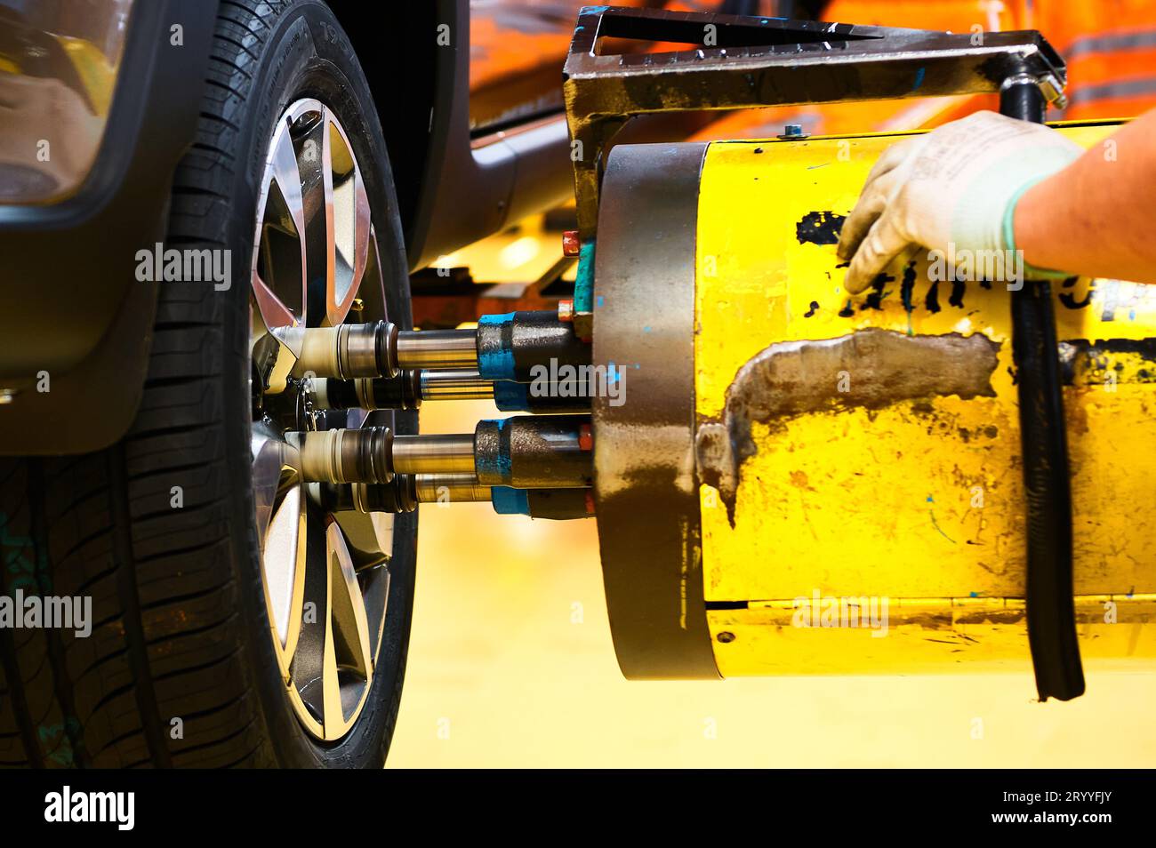 Employee fastens car wheel with automatic spanner in shop Stock Photo ...