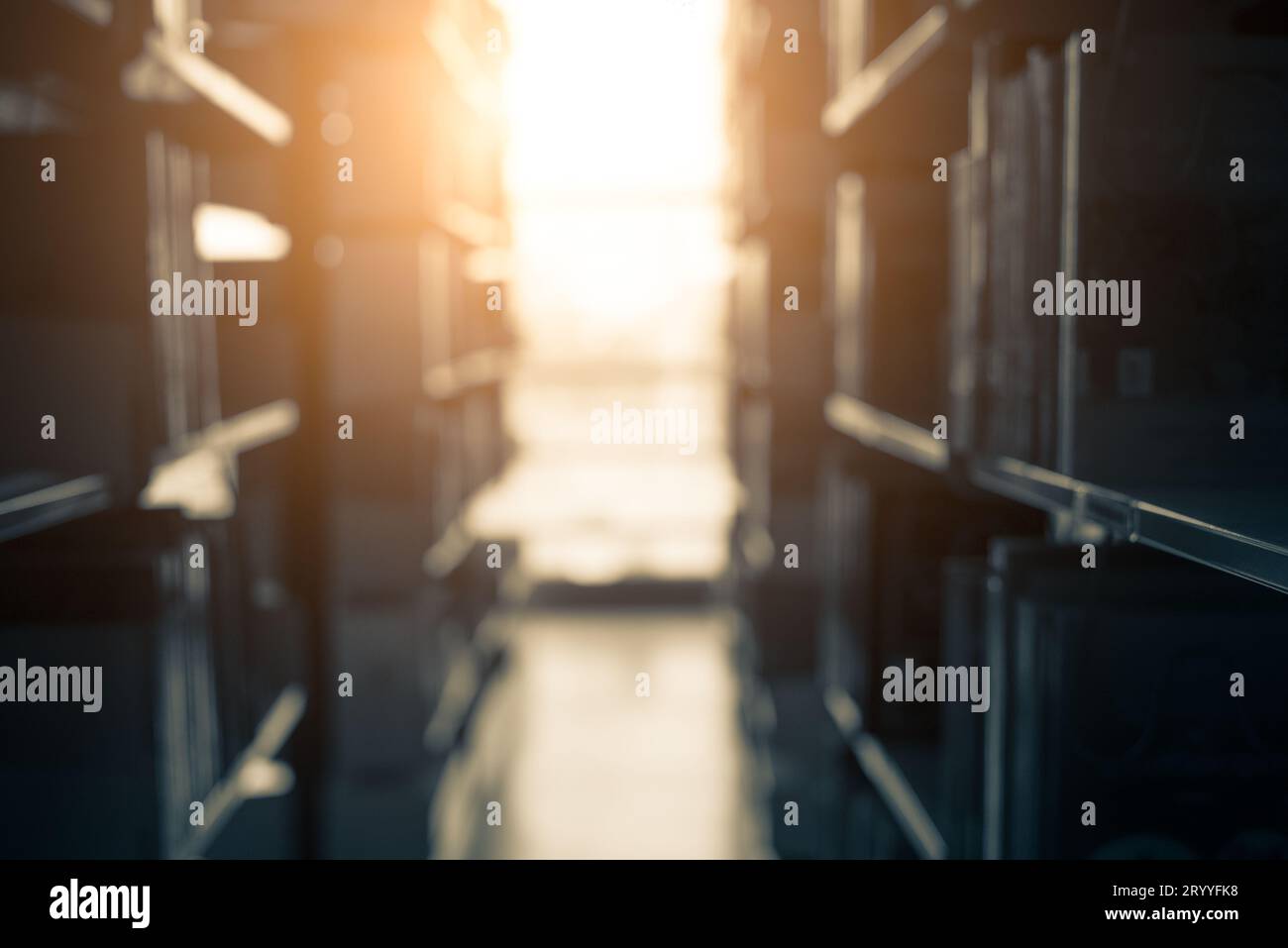 Blurry background of dark library with sunshine at the end. Education ...