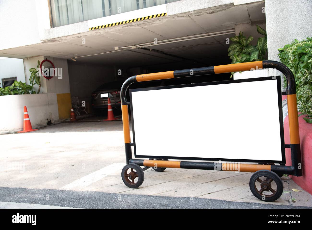 Blank white movable sign in front of car park. Traffic and ...