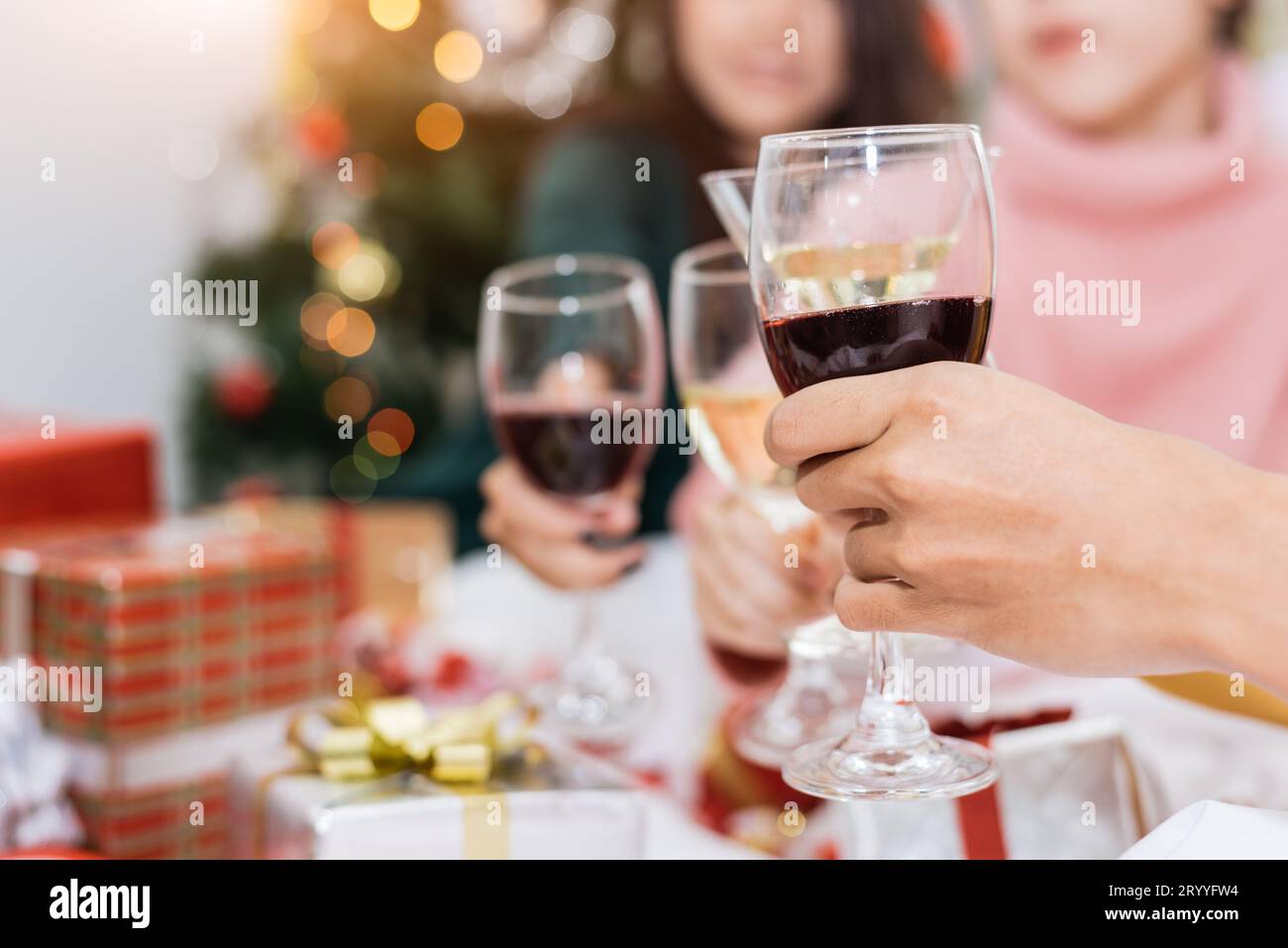 Hands of people celebrating New year party in home with wine drinking ...