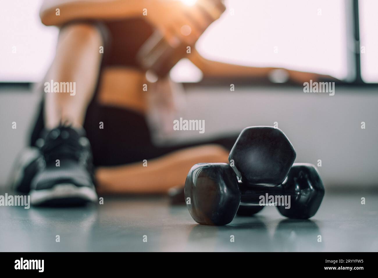 Close up of dumbbell with exercise woman lifestyle workout in gym ...