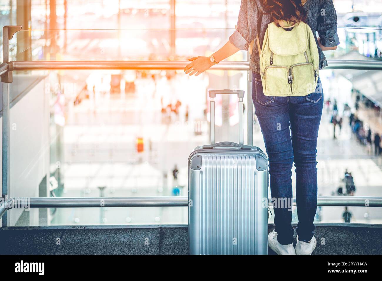 Close up of lower body of female traveler waiting for take off flight ...