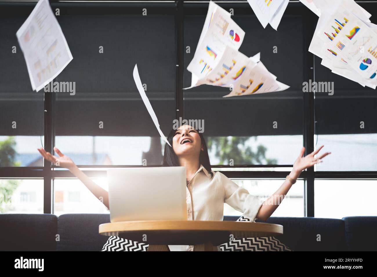Asian businesswoman throwing paperwork into the air. Successful and ...