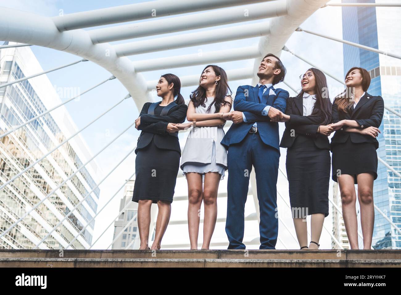 Portrait of successful group of business people looking up to sky as ...