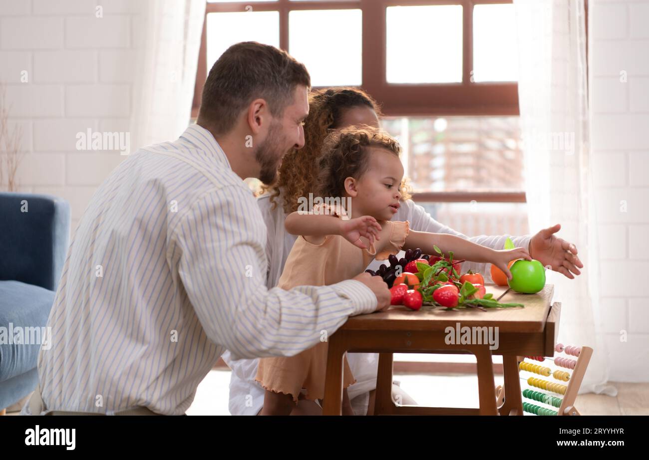 Parents and children relax in the living room of the house. Watch baby ...