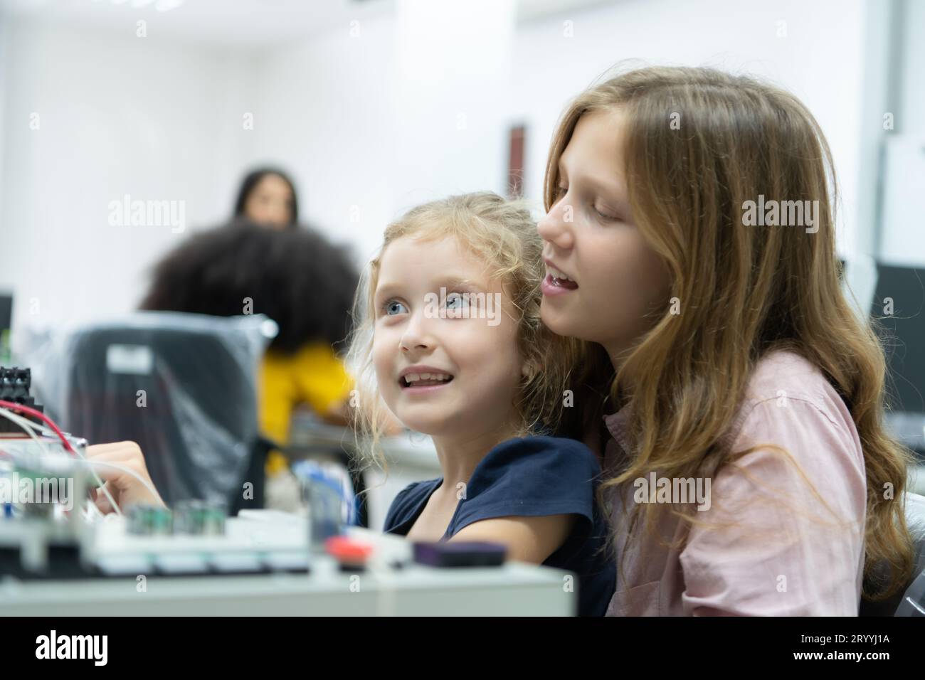 Children using the hand robot technology and having fun Learning the ...