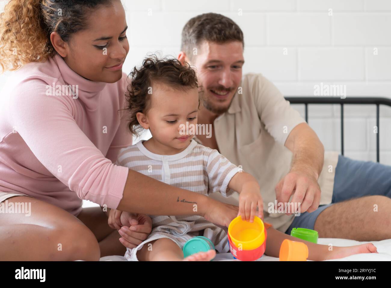 Parents with little girl have fun playing with your new toys in the ...