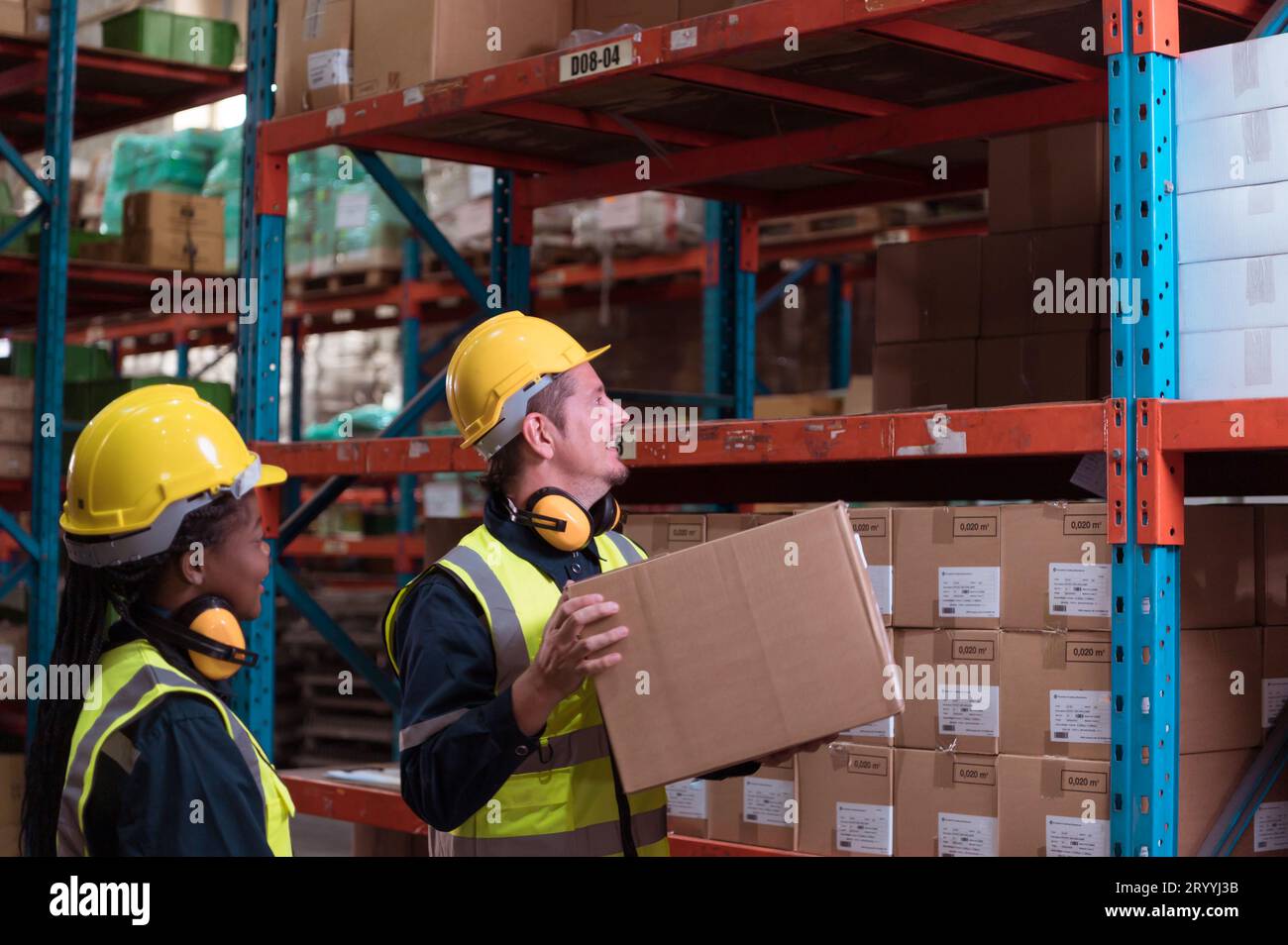 Foreman with employees in warehouse Help each other lift the product ...