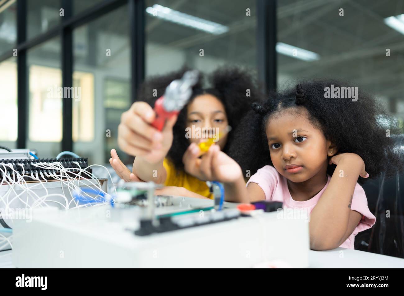 Children using the hand robot technology and having fun Learning the electronic circuit board of ...