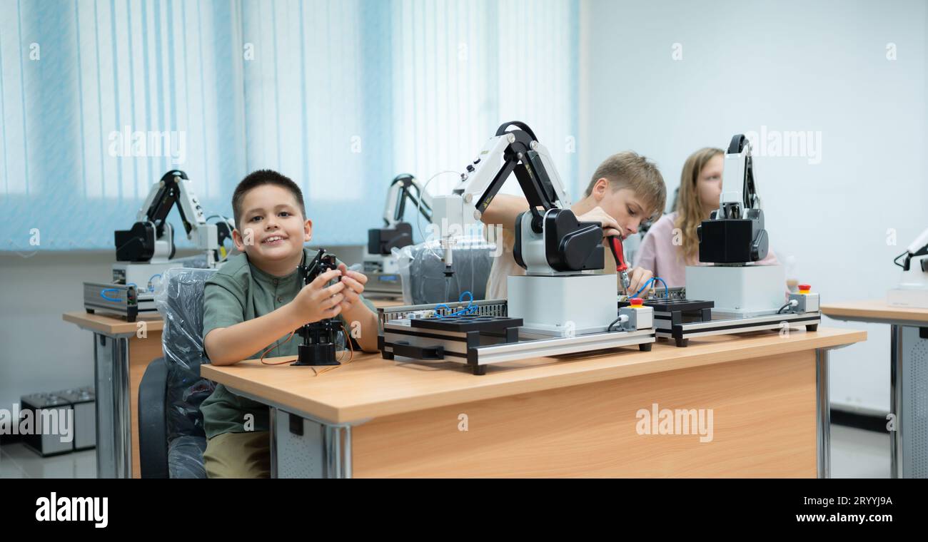 Children using the hand robot technology, Students are studying ...