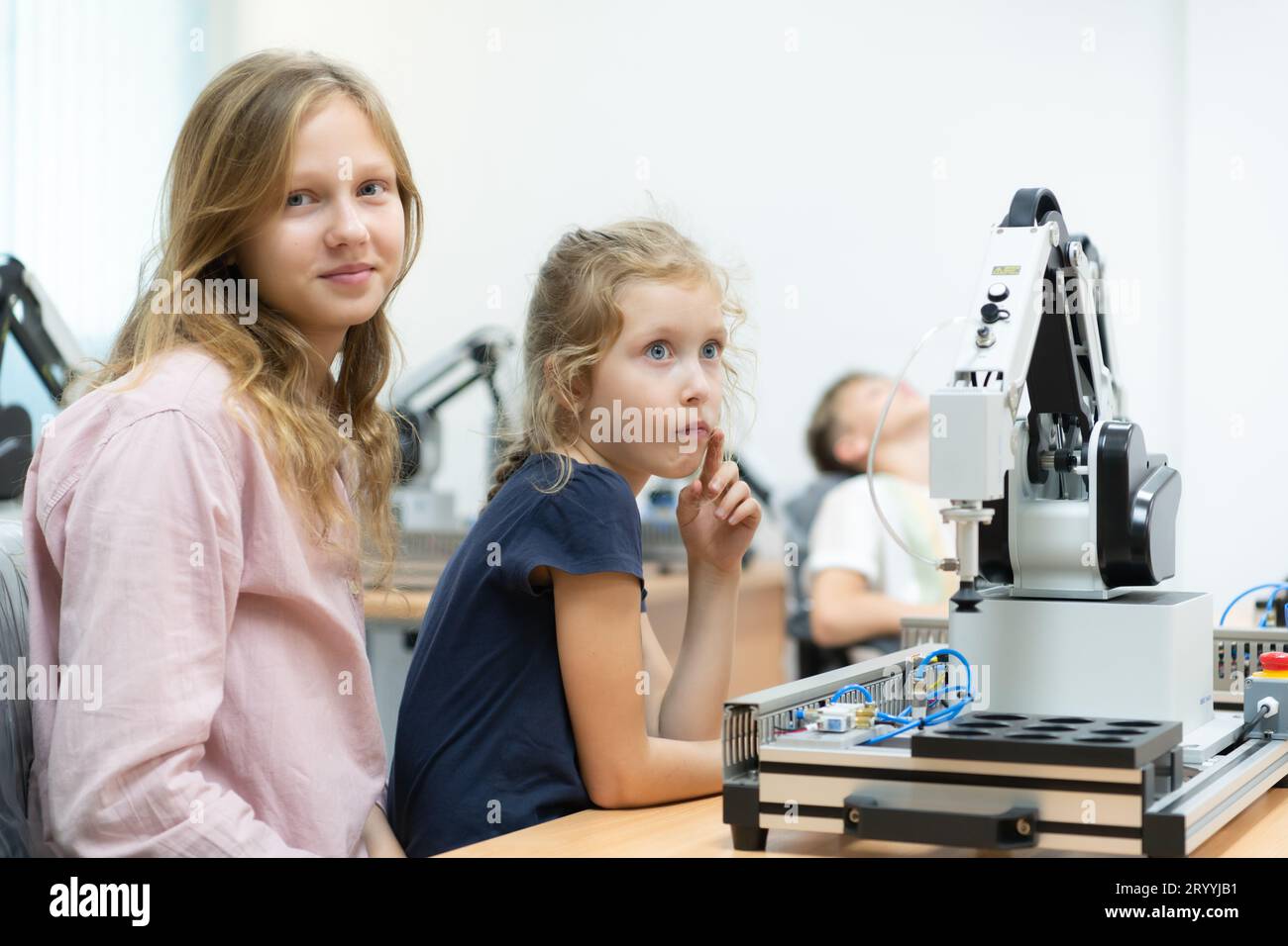 Children using the hand robot technology and having fun Learning the ...