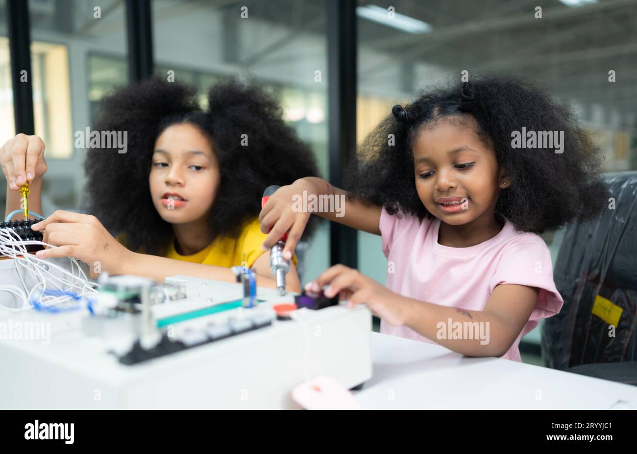 Children using the hand robot technology and having fun Learning the ...