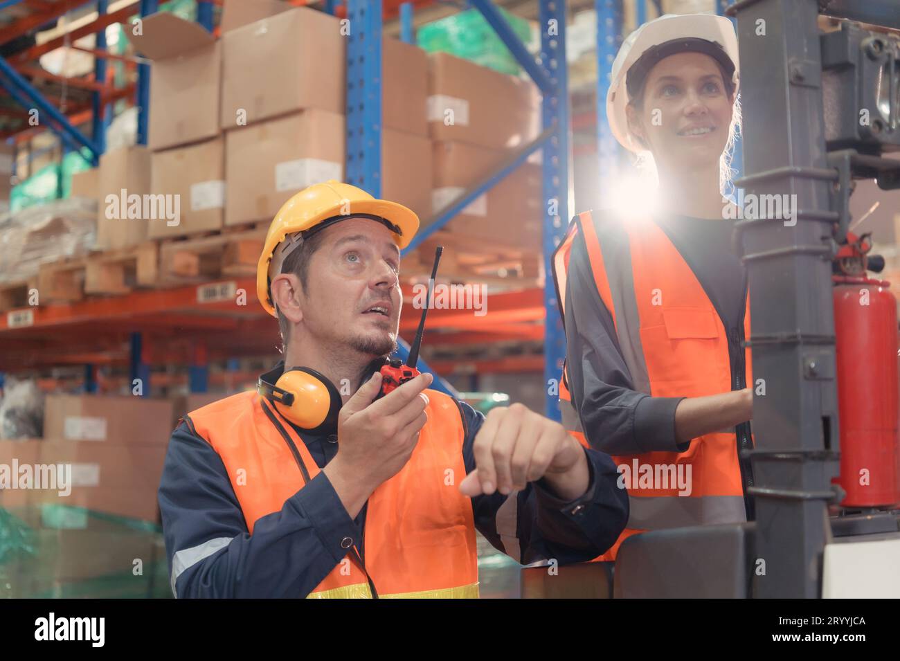 Manager with foreman discuss about the equipment used to move goods in ...