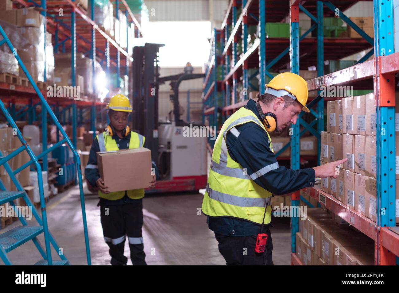 Foreman with employees in warehouse Help each other lift the product ...
