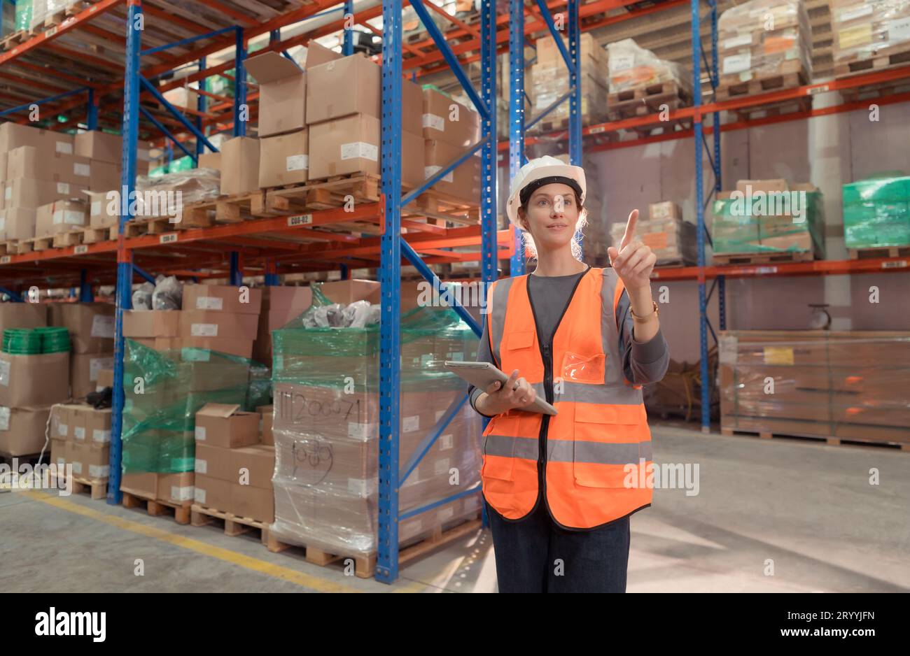 Portrait of warehouse supervisor in a large warehouse with their own ...