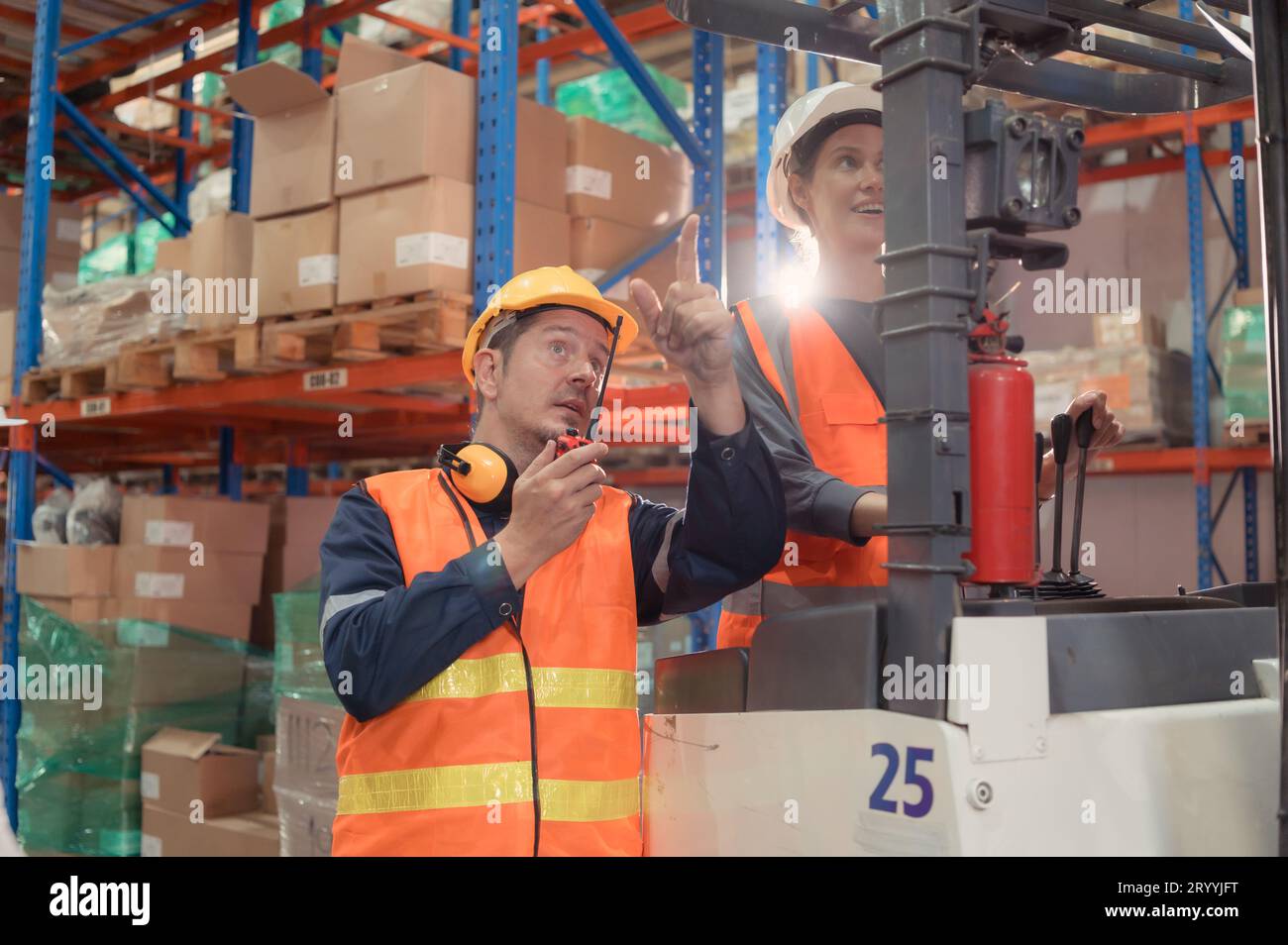 Manager with foreman discuss about the equipment used to move goods in ...