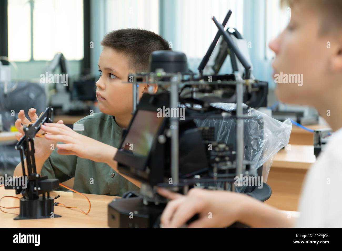 Children using the hand robot technology, Students are studying ...