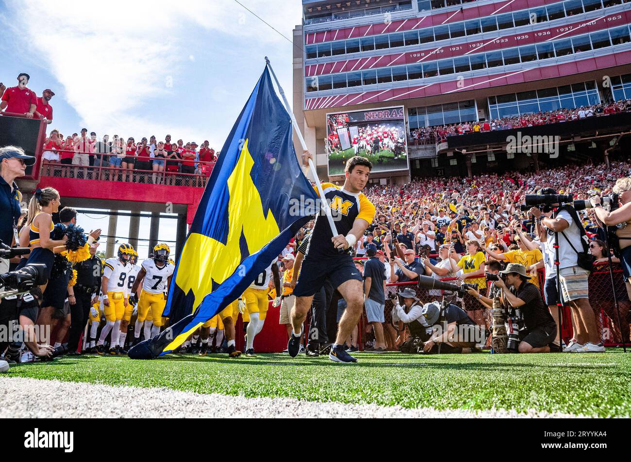 Lincoln, NE. U.S. 30th Sep, 2023. Michigan Wolverines flag runs ahead of the team as they enter ...