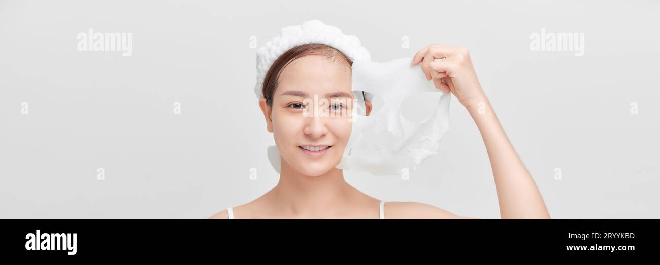 Woman with a sheet moisturizing mask on her face isolated on white ...