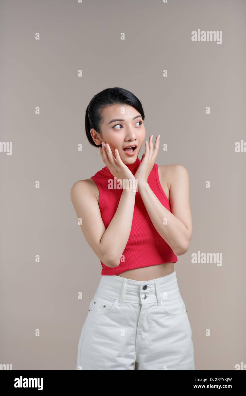 Beautiful girl acts like a telling something isolated on beige ...