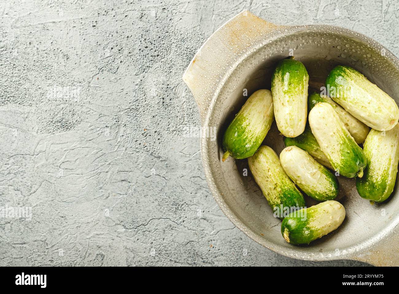 Baby cucumber on gray background Stock Photo - Alamy