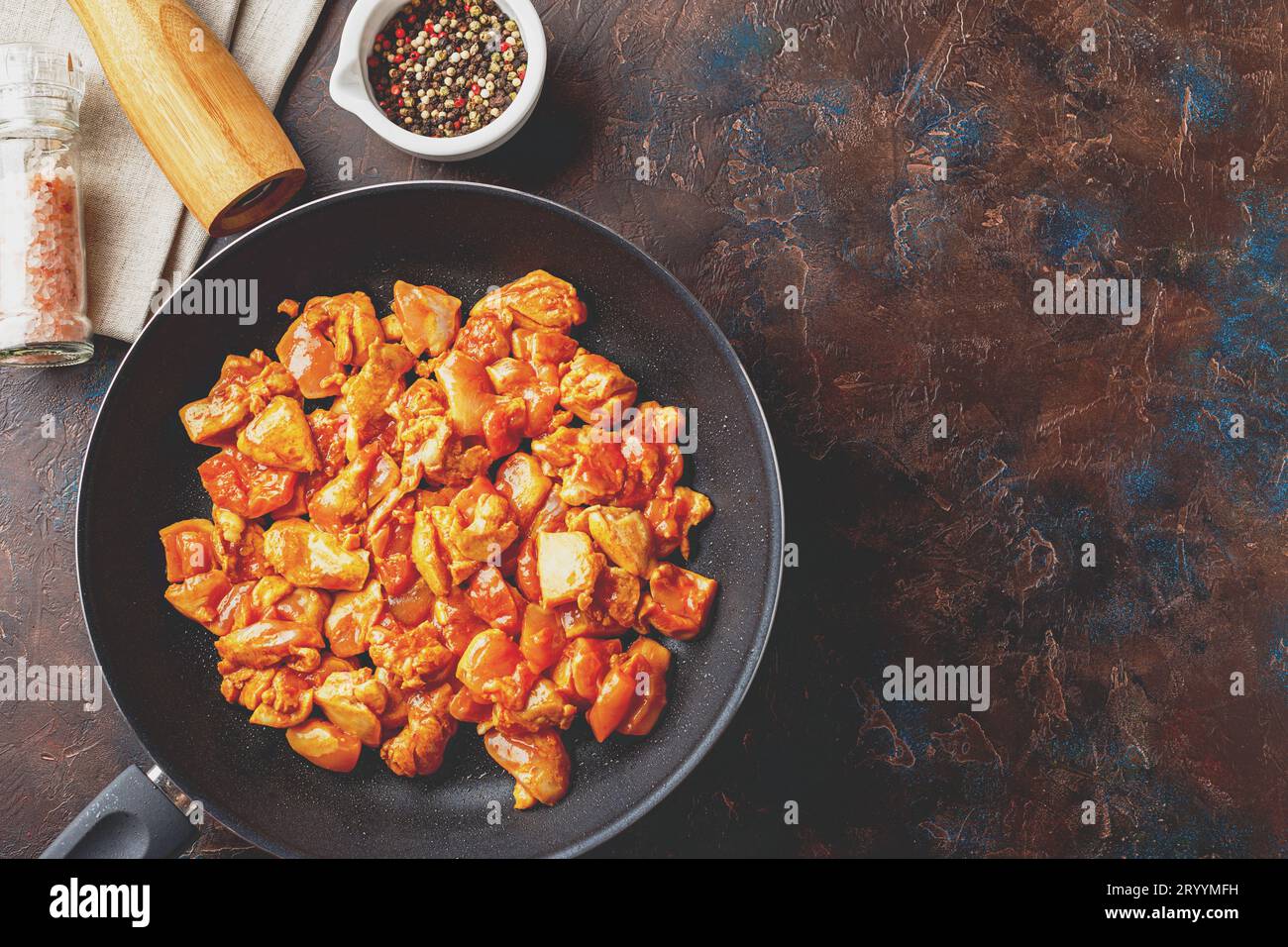 Chicken fillet cut into small pieces for frying in pan Stock Photo - Alamy