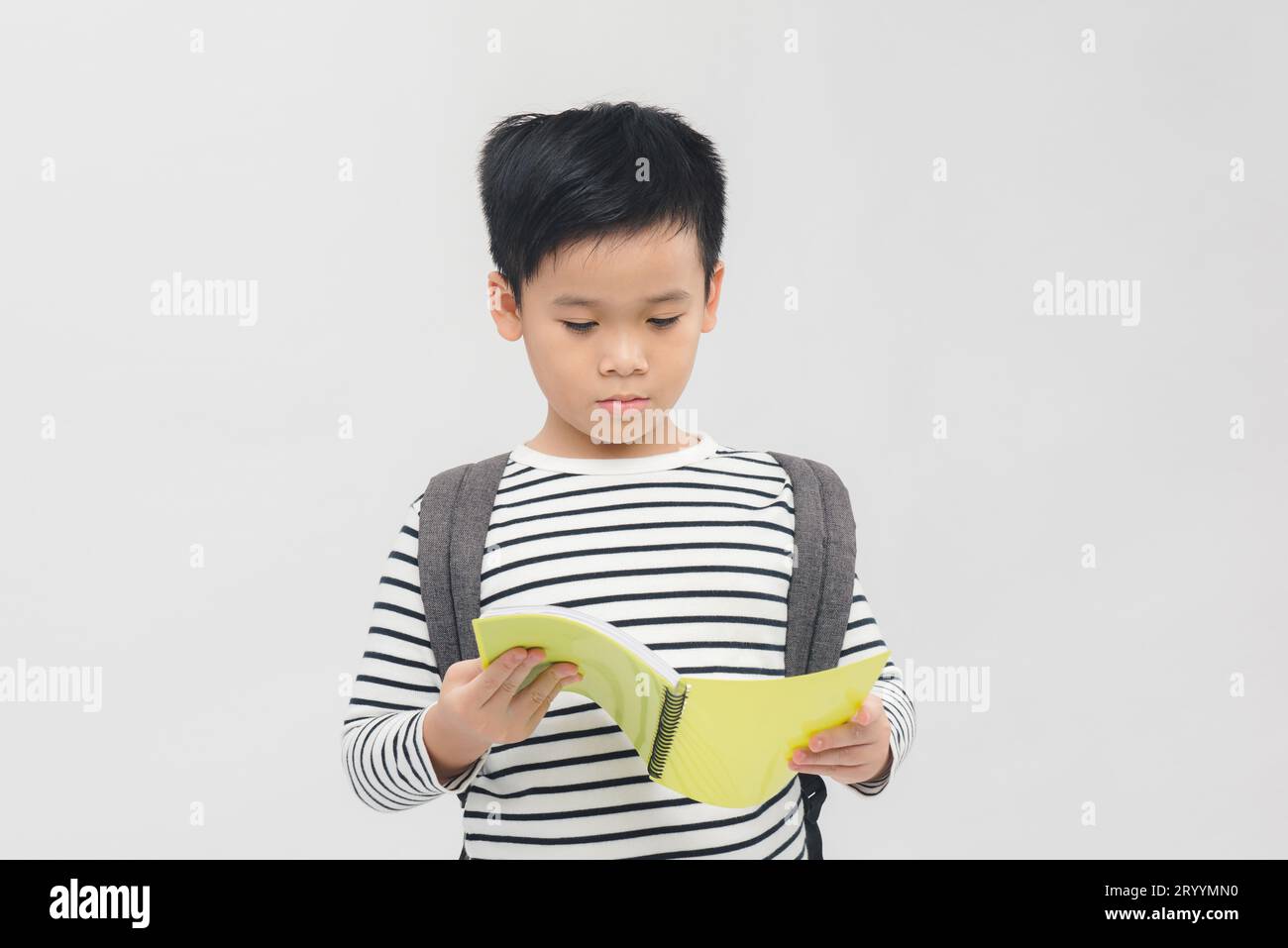 Asian school boy, holding notebooks, isolated on white background ...