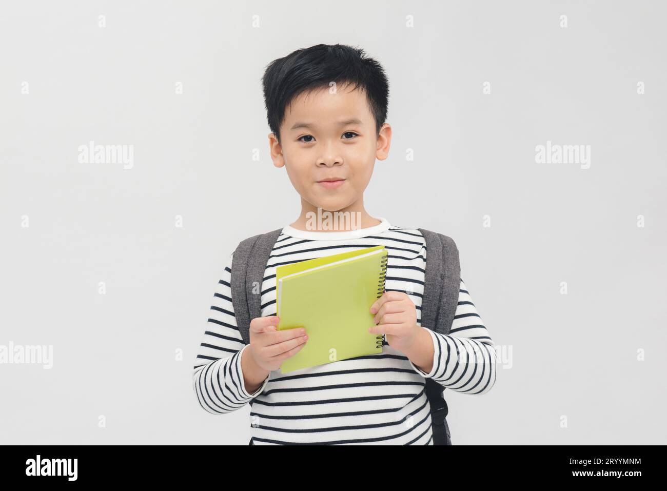 Asian school boy, holding notebooks, isolated on white background ...