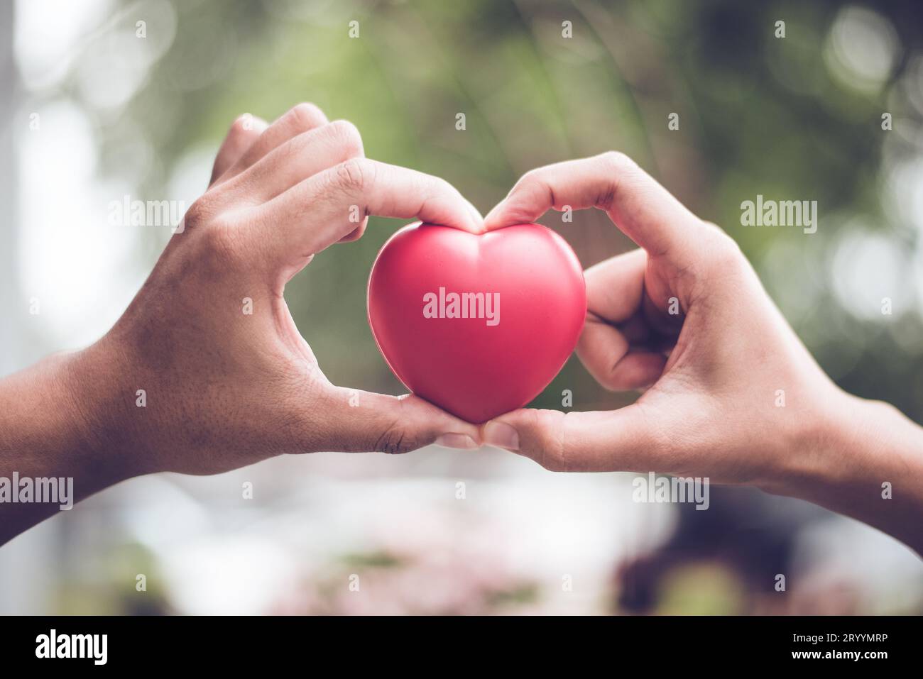 Couple in love making heart symbol shape with finger and hands ...