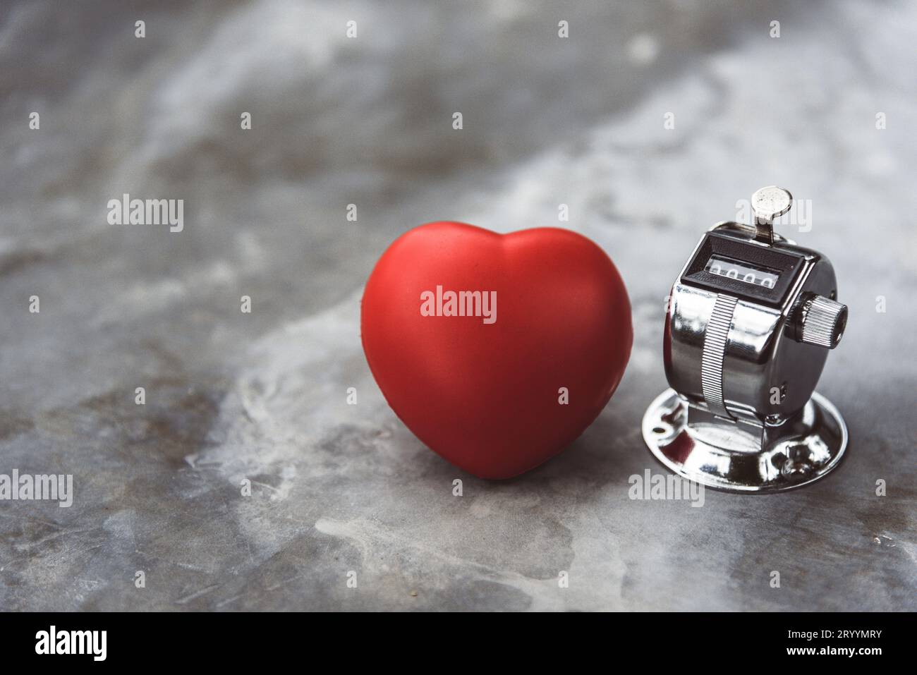 Heart and countdown counter on marble table surface. Medical and health ...