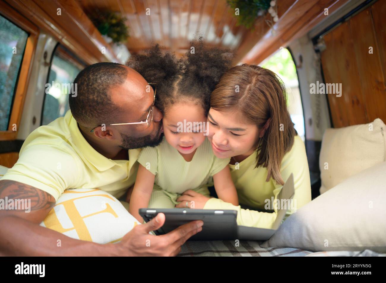 The back of a white classic van, little kids play and learn about the ...