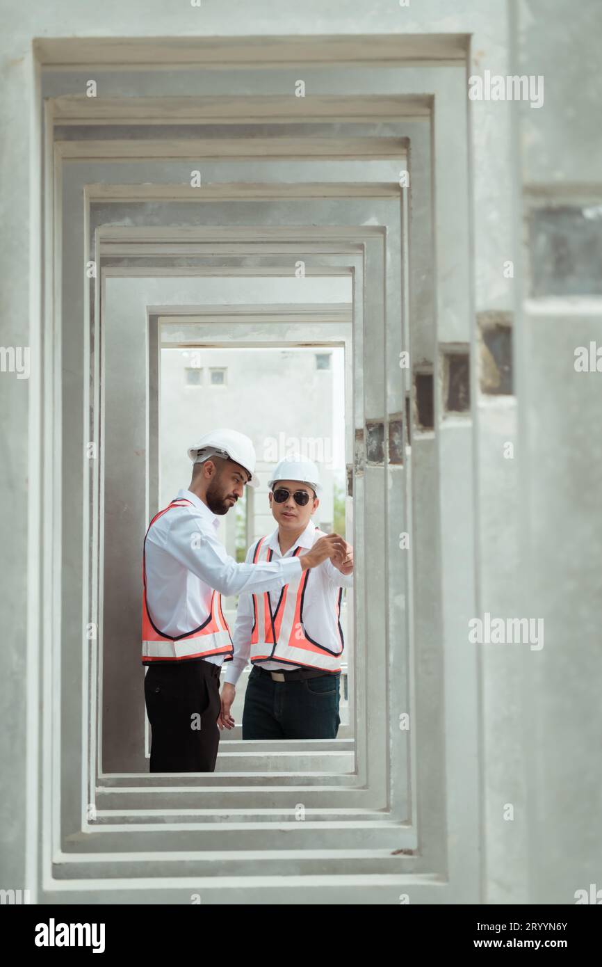 Both of construction engineers verify the constructed precast concrete ...