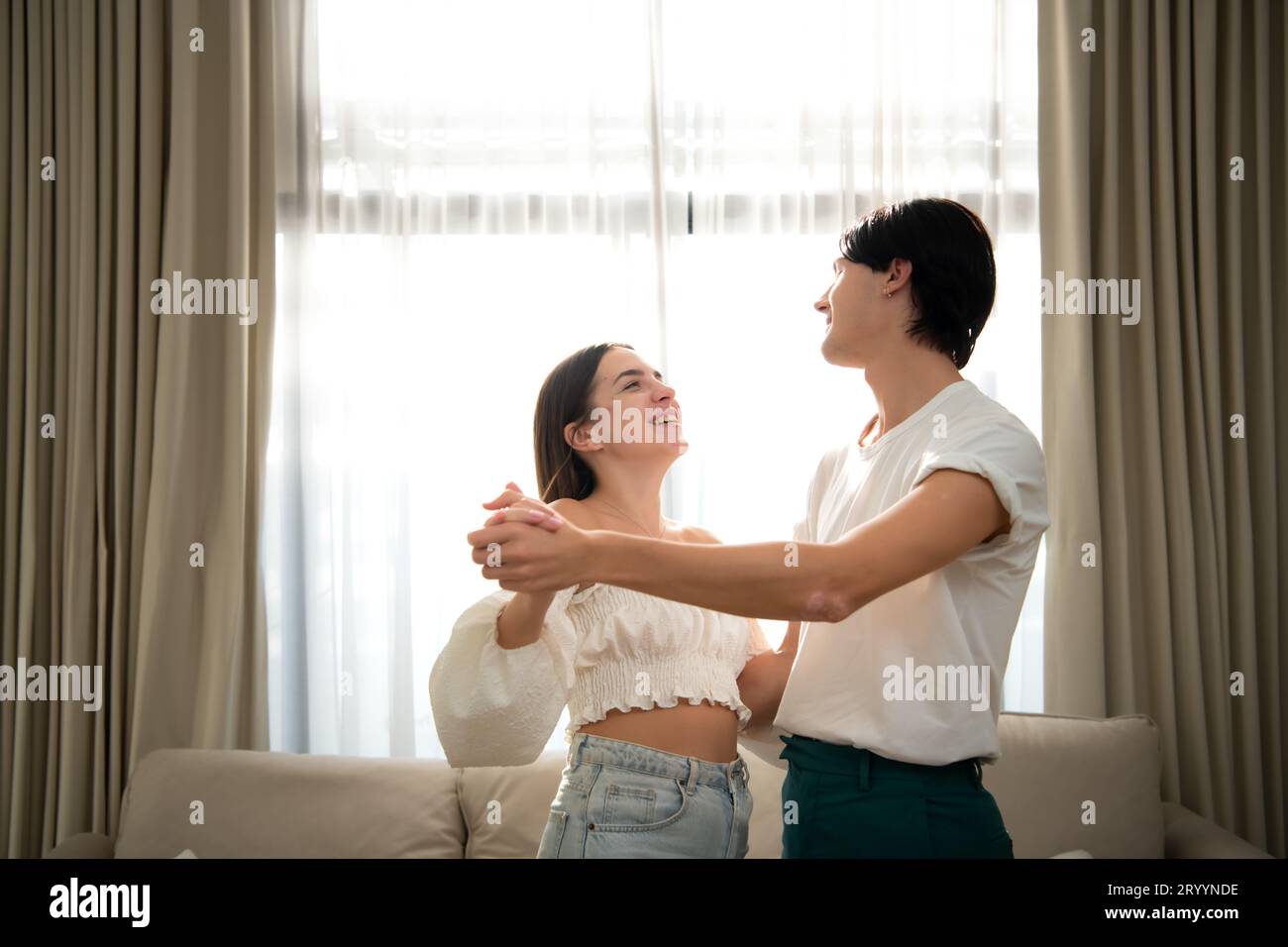 Young couple in the living room of the house in the morning, Dancing ...