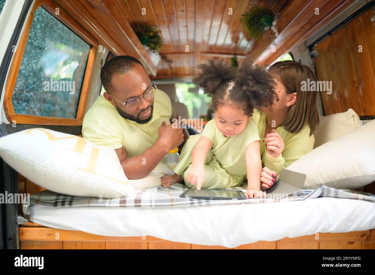 The back of a white classic van, little kids play and learn about the ...