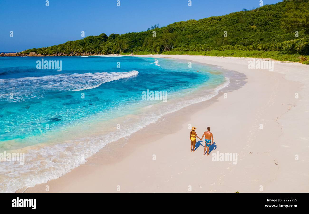 Anse Cocos La Digue Seychelles, a young couple of men and women on a ...