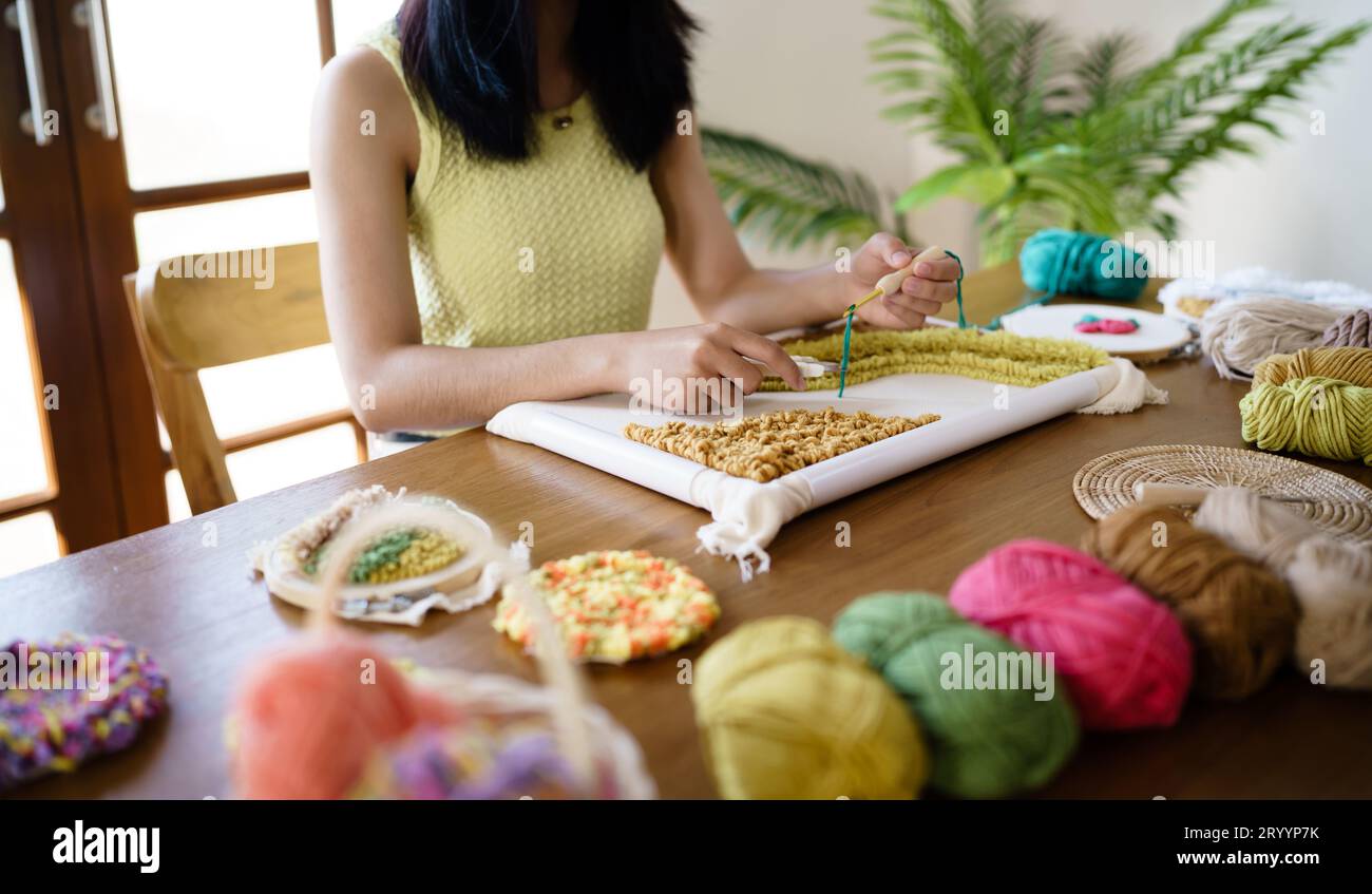 Punch needle. Asian Woman making handmade Hobby knitting in studio ...