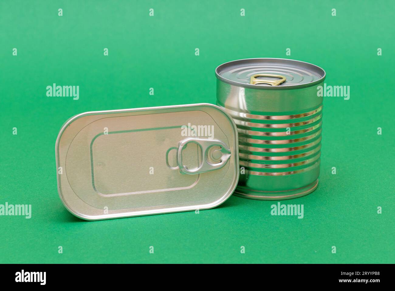 A Group of Stacked Tin Cans with Blank Edges on Green Background ...