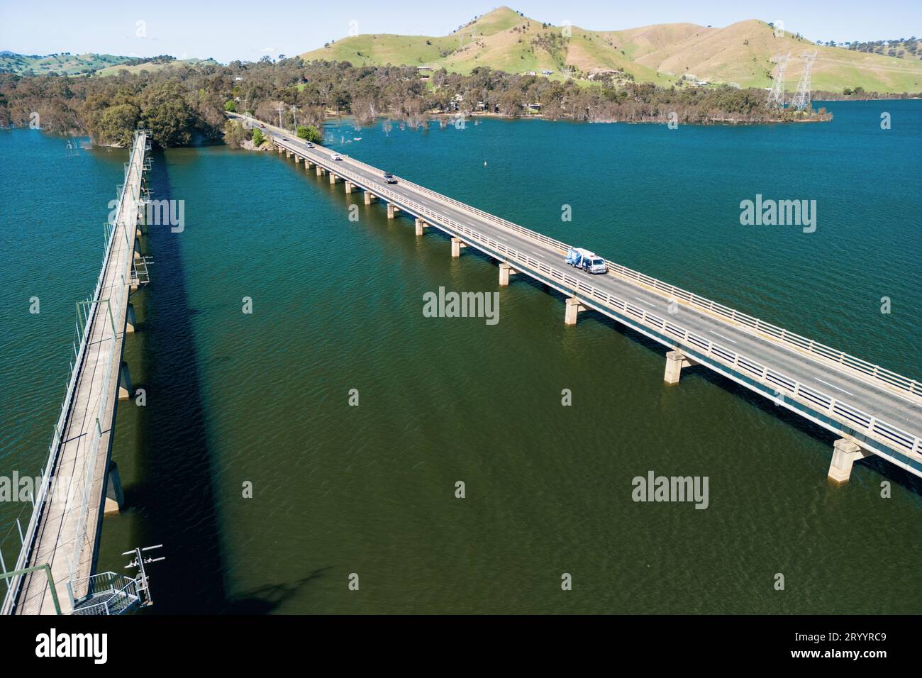 An aerial view of a walk bridge running parallel with a traffic bridge ...