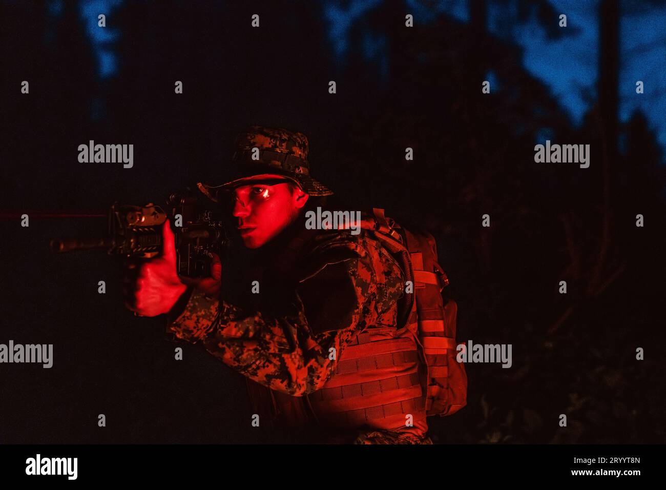 Soldiers squad in action on night mission using laser sight beam lights ...