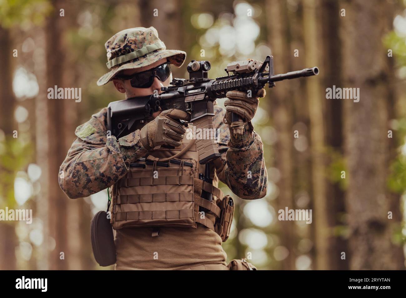 A modern warfare soldier on war duty in dense and dangerous forest ...