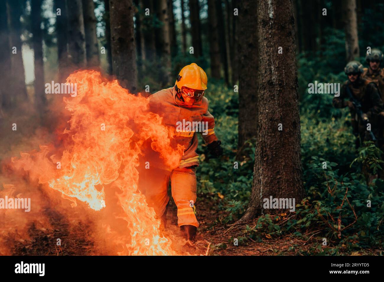Firefighter hero in action danger jumping over fire flame to rescue and ...