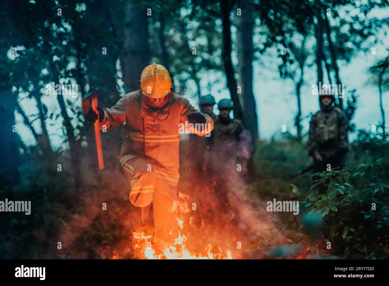 Firefighter hero in action danger jumping over fire flame to rescue and ...