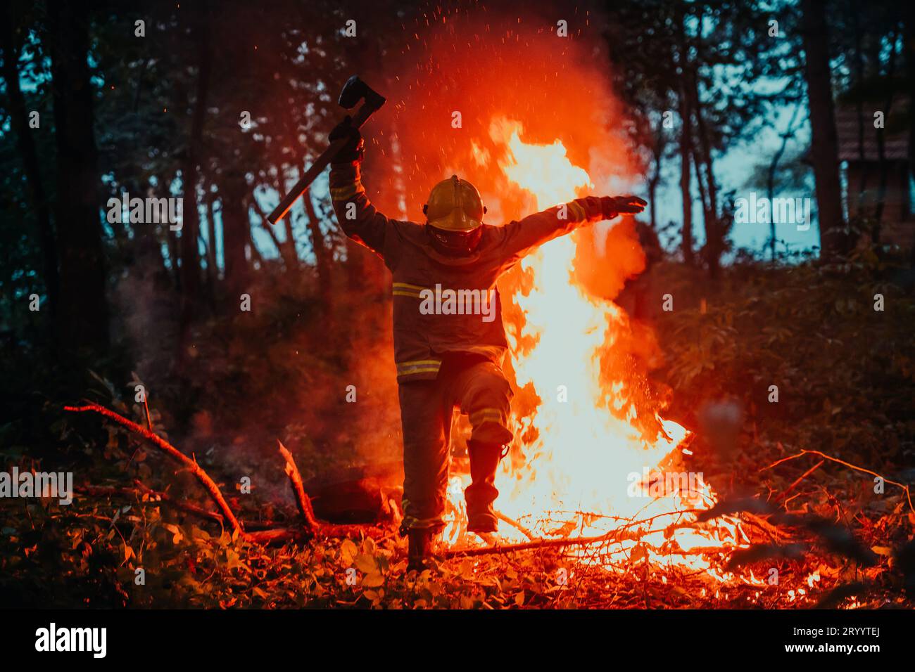 Firefighter hero in action danger jumping over fire flame to rescue and ...