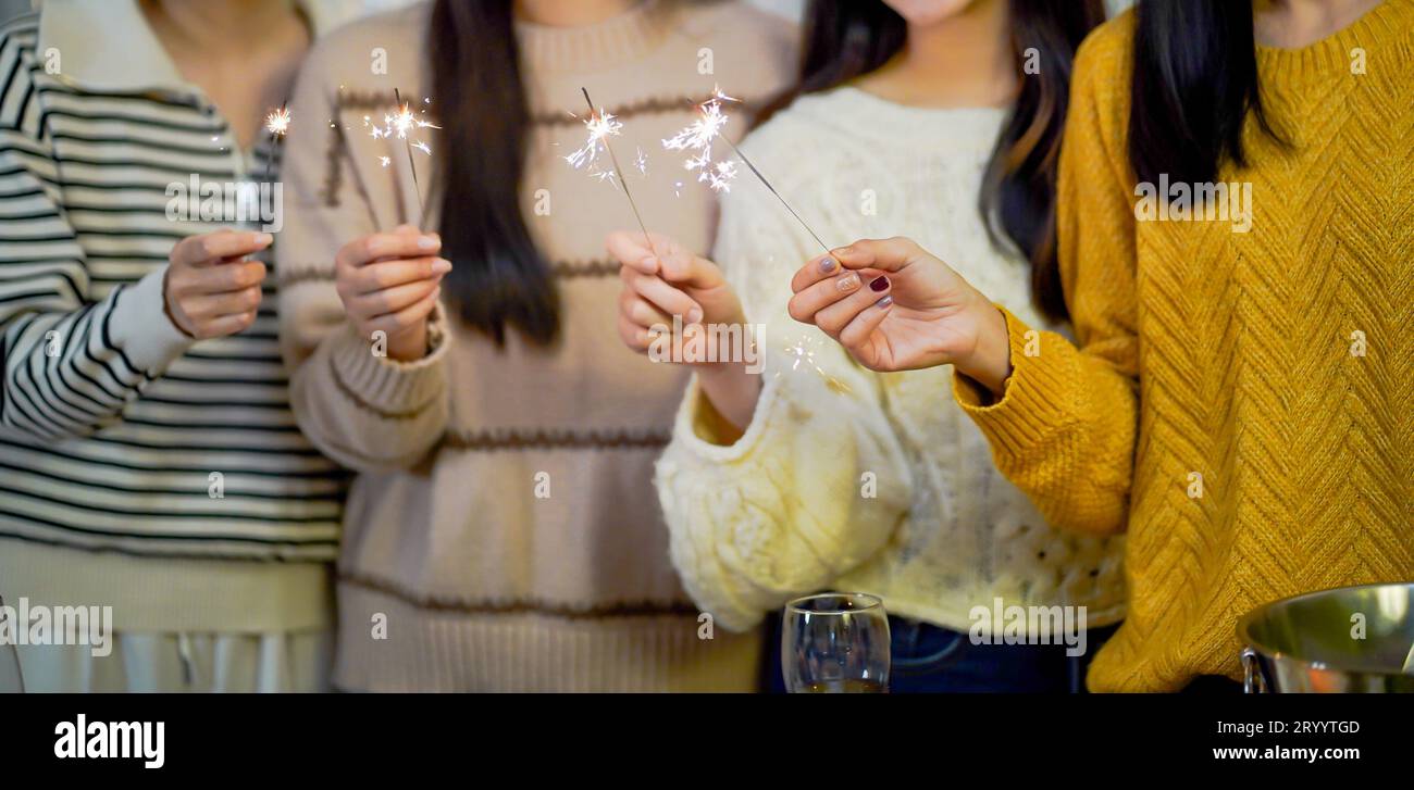 Cheerful friends enjoying home Birthday holiday party. Asian Friends ...