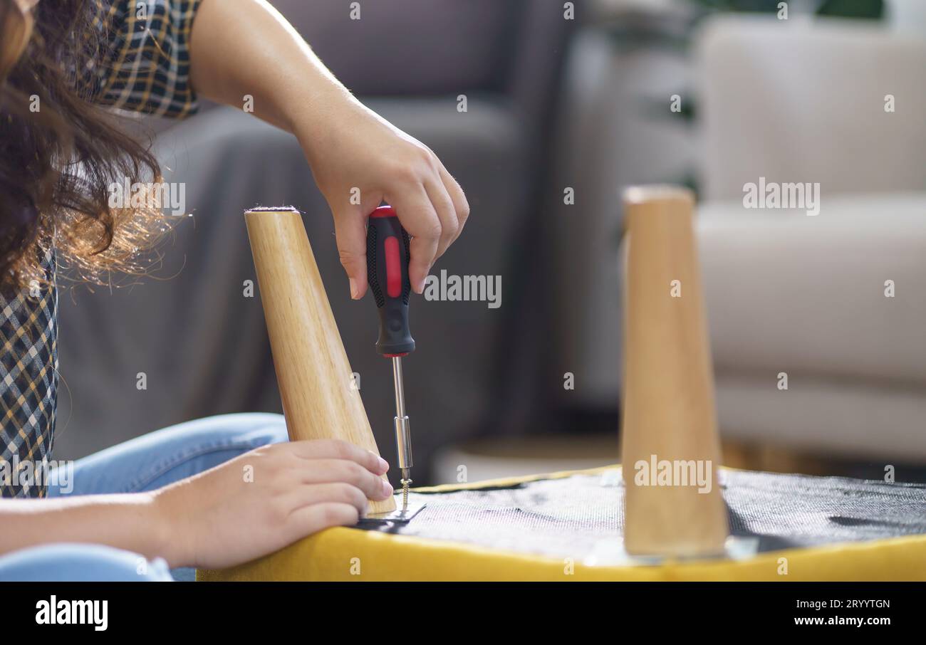 Asian Woman self repairs furniture renovation using equipment to diy ...