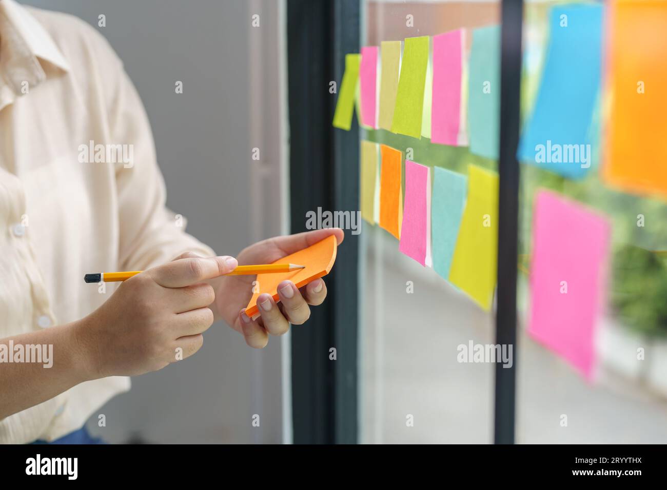 Business People working on sticky notes creative writing down ideas on ...