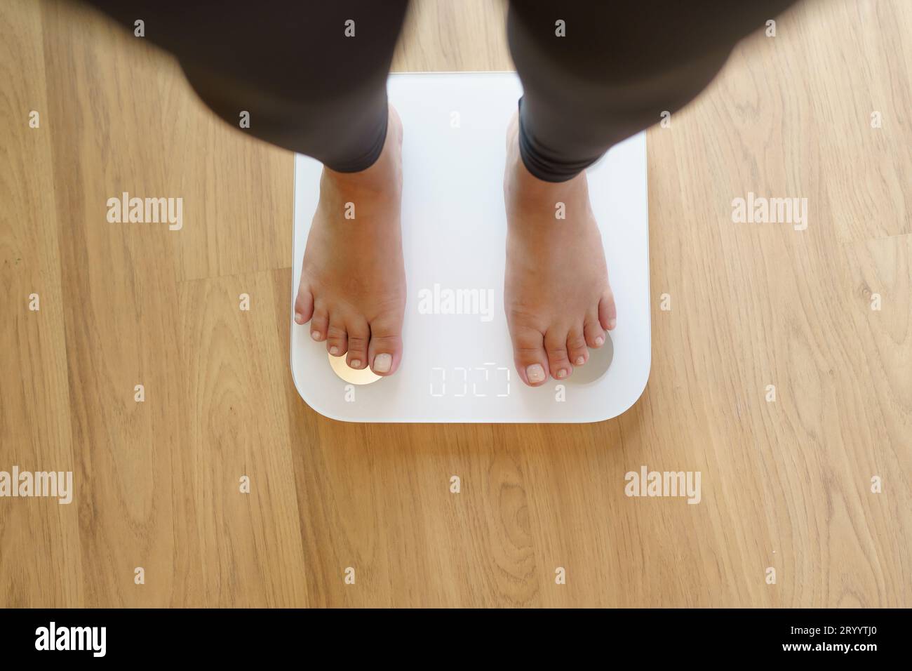 Lose weight. Fat diet and scale feet standing on electronic scales for ...
