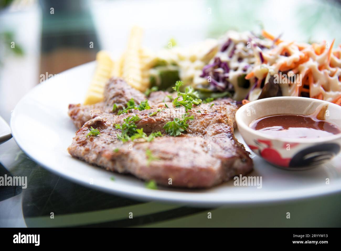 Pork chop steak with salad and gravy sauce in dish. Food and Vegetable ...